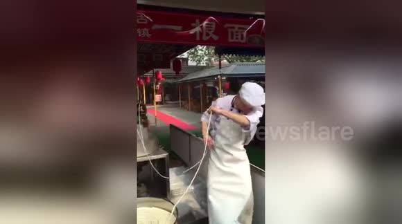 Enthusiastic man dances while he pulls one-strand noodle - Buy, Sell or ...