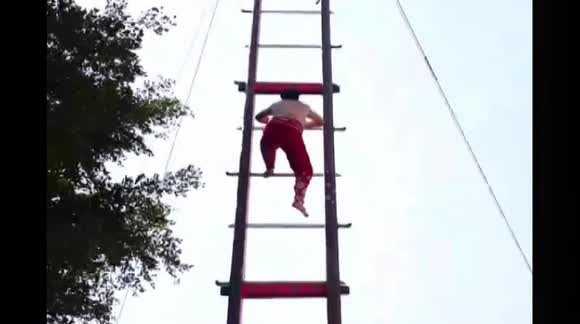 Man climbs sword ladder during village festivities - Buy, Sell or ...