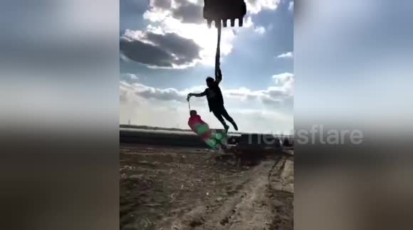 Construction worker dances with dummy while hanging on excavator - Buy ...