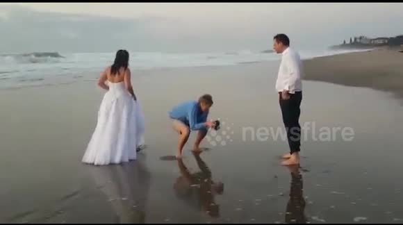 Freak wave knocks bride over on beach during photo shoot - Buy, Sell or ...