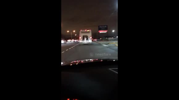 PILLAR-BOXED VERSION: Two kids hitching a ride on the back of a MTA bus ...