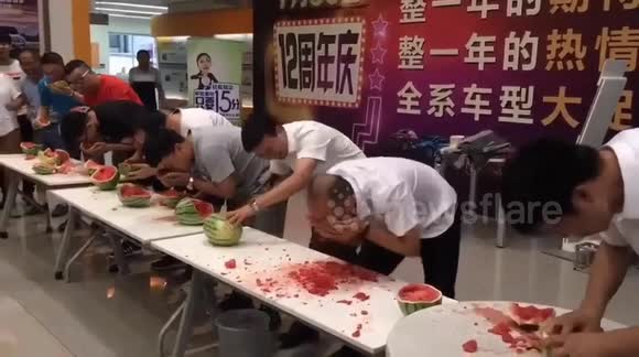 Man plunges face into watermelon to win eating contest - Buy, Sell or ...