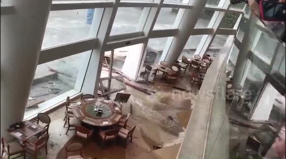 Hotel guests look on in horror as floodwaters crash into dining room ...