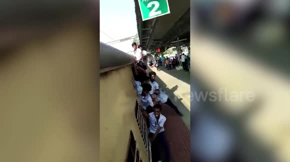 Boys risk life by dangling from moving train in southern India - Buy ...