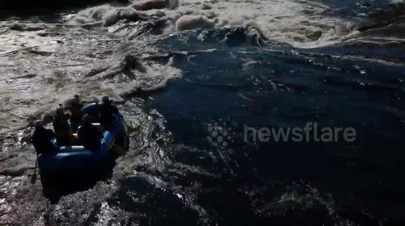 White water raft carrying 5 people is flipped over by huge wave on ...