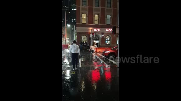Man attempts to 'fight' rain while standing in the middle of a road in ...