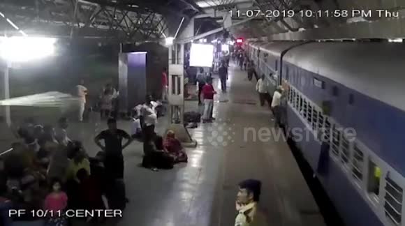 Commuters rush to save woman from being run over by train in western ...