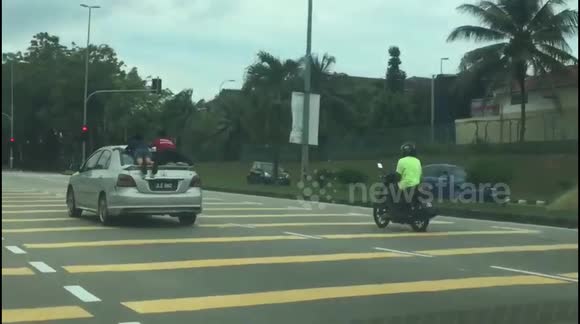 Reckless driver in Malaysia is caught jumping red light with two ...