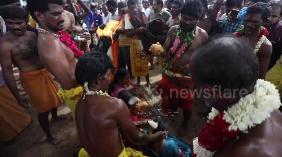 Smashing it! Devotees line up to have coconuts broken on their heads in ...