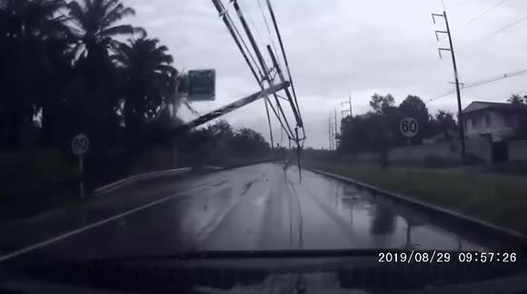 Terrifying moment electricity pylons are blown onto car during Thai ...