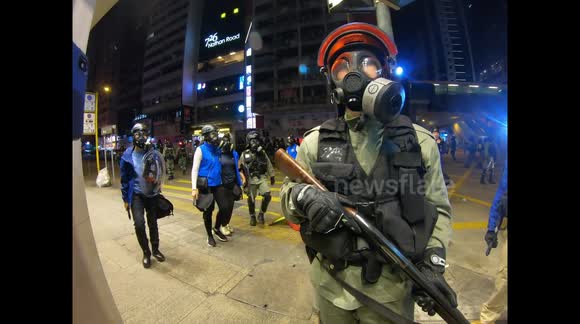 Hong Kong riot police confront journalists and push them in front of ...