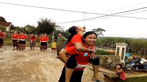 The women taking part in the challenge use their mouth eating apples on ...