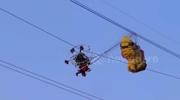 Chinese paraglider rescued after parachute becomes tangled on high ...
