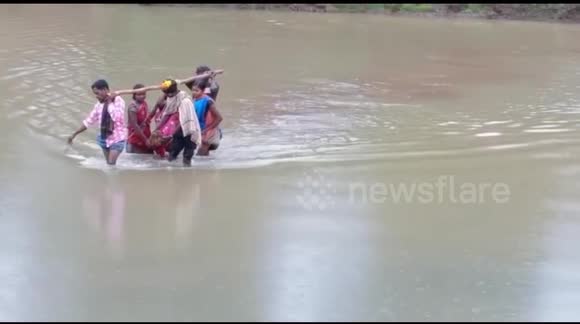 Family members carry pregnant woman on sling across river - Buy, Sell ...