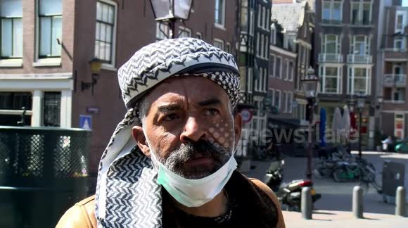 Homeless man surviving corona on empty streets of Amsterdam red light ...