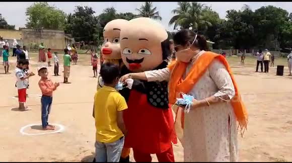 Indian cartoon character Motu-Patlu distributes masks for children in ...