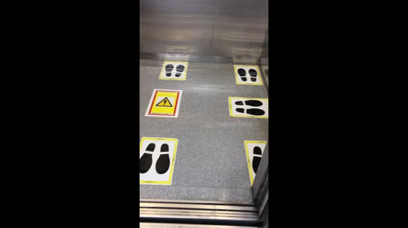 Floor stickers used to regulate social distancing in Japanese elevators ...