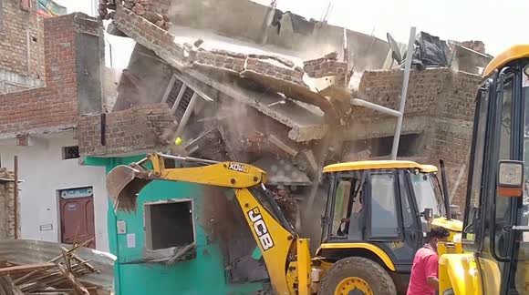 JCB driver has close shave when building collapses around his vehicle ...