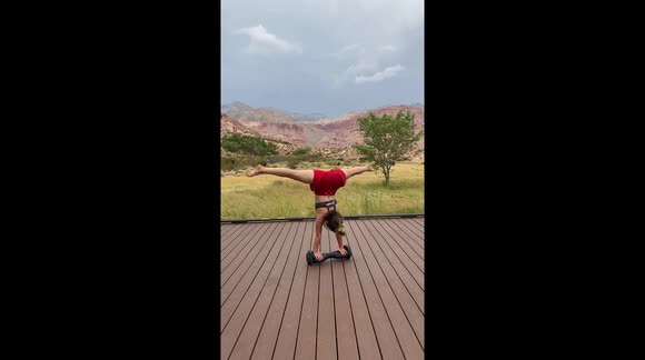 US girl does yoga poses while balancing on rotating hoverboard - Buy ...