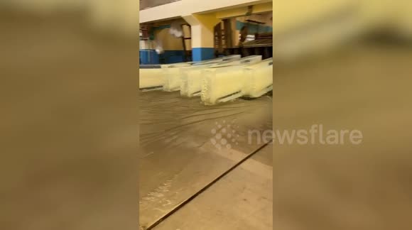 Weirdly satisfying footage of giant ice cubes sliding along factory ...