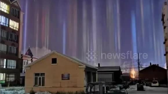 Ice crystal reflections form light pillars above Chinese city in ...
