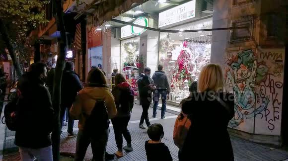 People form lines out of Christmas retail stores to buy trees and ...