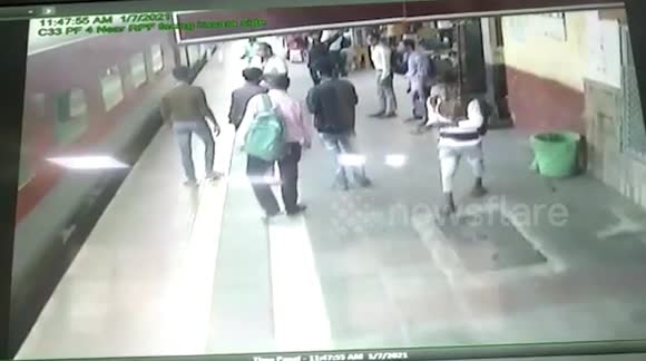 Alert railway cop saves elderly couple from being run over by train in ...