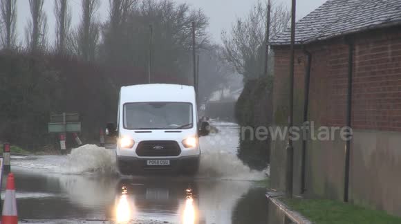 Vehicles struggle to pass through submerged roads as flooding strikes ...