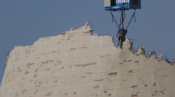 A huge tool is used to demolish water cooling tower of Bazan oil ...