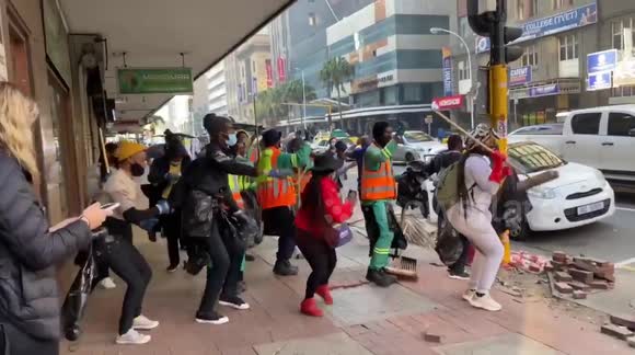 South African clean-up crews dance as they clear mess from looting in ...