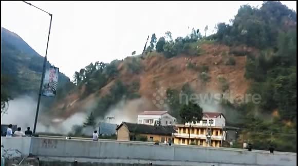 Residents watch on as mountainside collapses due to continuous rainfall ...