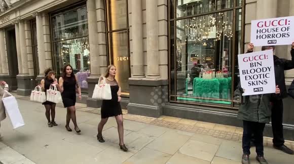 PETA activists stage a catwalk outside Gucci with bloody handbags in ...