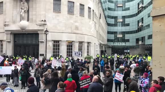 Thousands of NHS workers gather outside the BBC to oppose mandatory ...