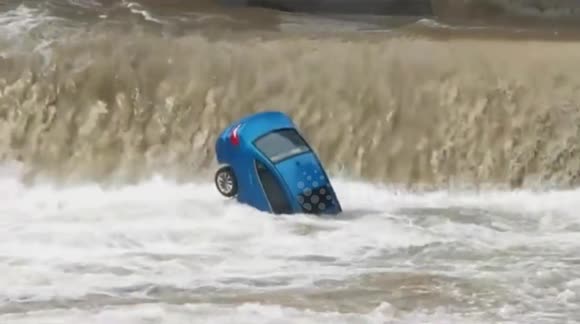 Car washed into bridge as heavy rain transforms street into river in ...