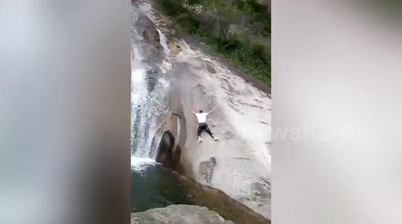 Dramatic moment man falls down waterfall after attempting to run across ...