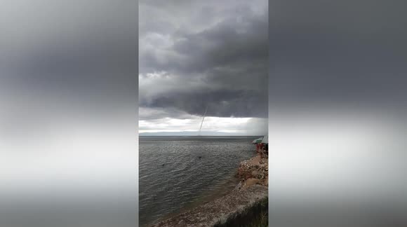 Long waterspout sparks panic among villagers after forming off the ...
