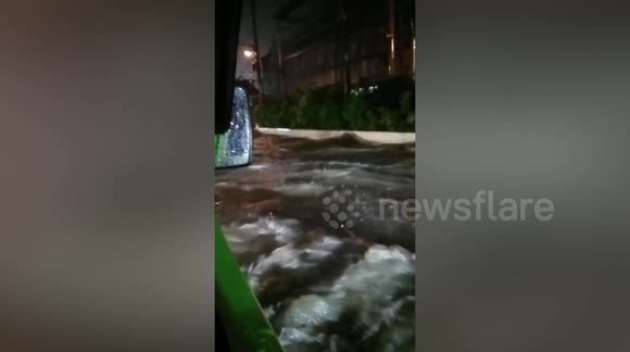 Water sloshes on flooded road following monsoon rains in the ...