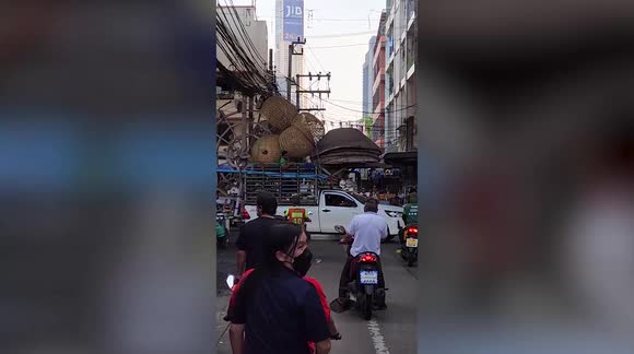 Overloaded pickup stuck after being caught under messy electric cables ...