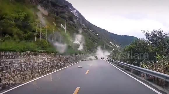 Car reverses to avoid being hit by rocks rolling down mountain - Buy ...