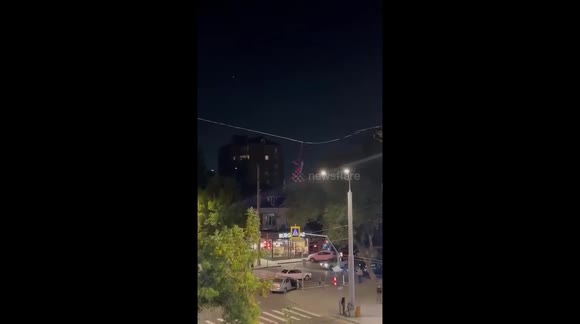 Man in Spider-Man costume seen dangling from wires across road in ...