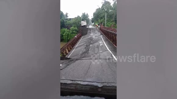 Bridge collapses when overloaded truck carrying sand drives across in ...