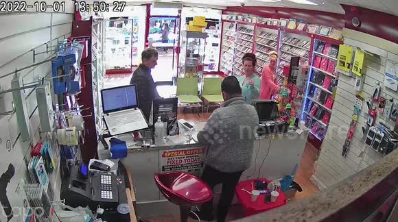 Bizarre moment female thief distracts shopkeeper by dancing while pal ...