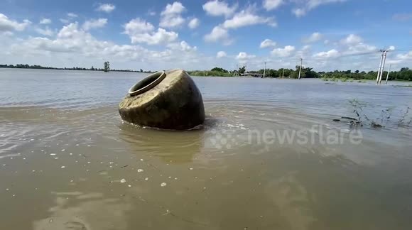 Large clay water jug found floating next to road amid floods in ...