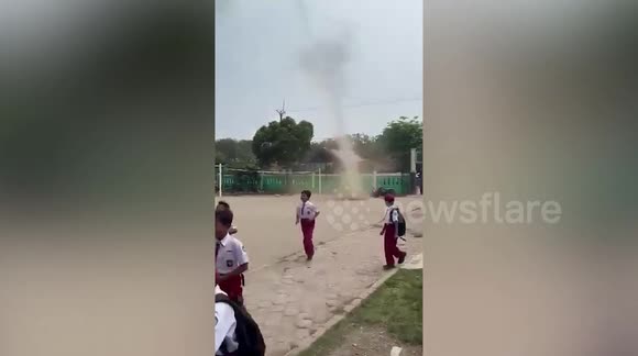 Pupils flee from enormous dust devil that formed in school grounds in ...