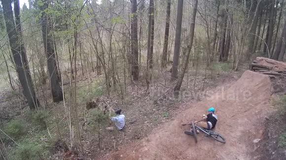 Mountain bikers collide together in has hard crazh while jumping big ...