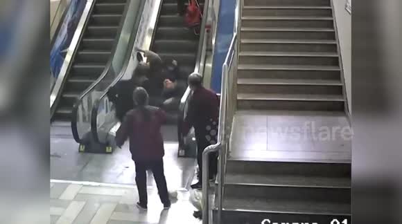 Man sprints to rescue elderly woman tumbling down escalator in China ...