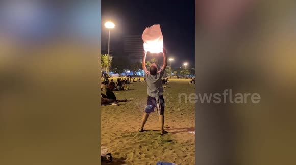 Drunk tourist repeatedly fails when launching lantern into sky during ...