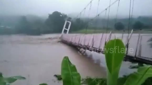 Bridge collapses as rain-swollen river erodes its foundation in the ...
