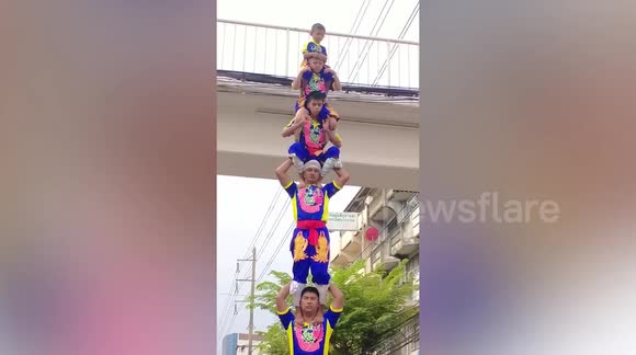Cute little girl stands on top of amazing human acrobatic tower during ...