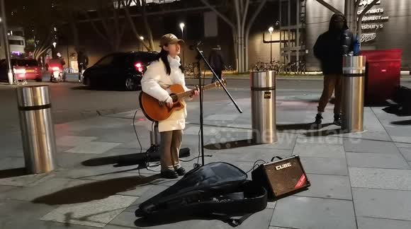 A young Chinese girl busking, singing Mandarin, London, UK - Buy, Sell ...